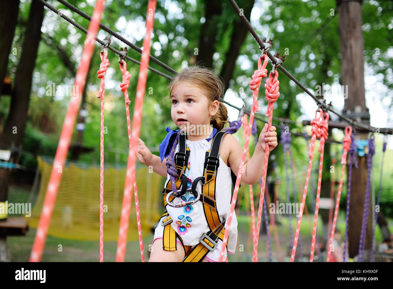 baby girl on a rope park background Stock Photo - Alamy