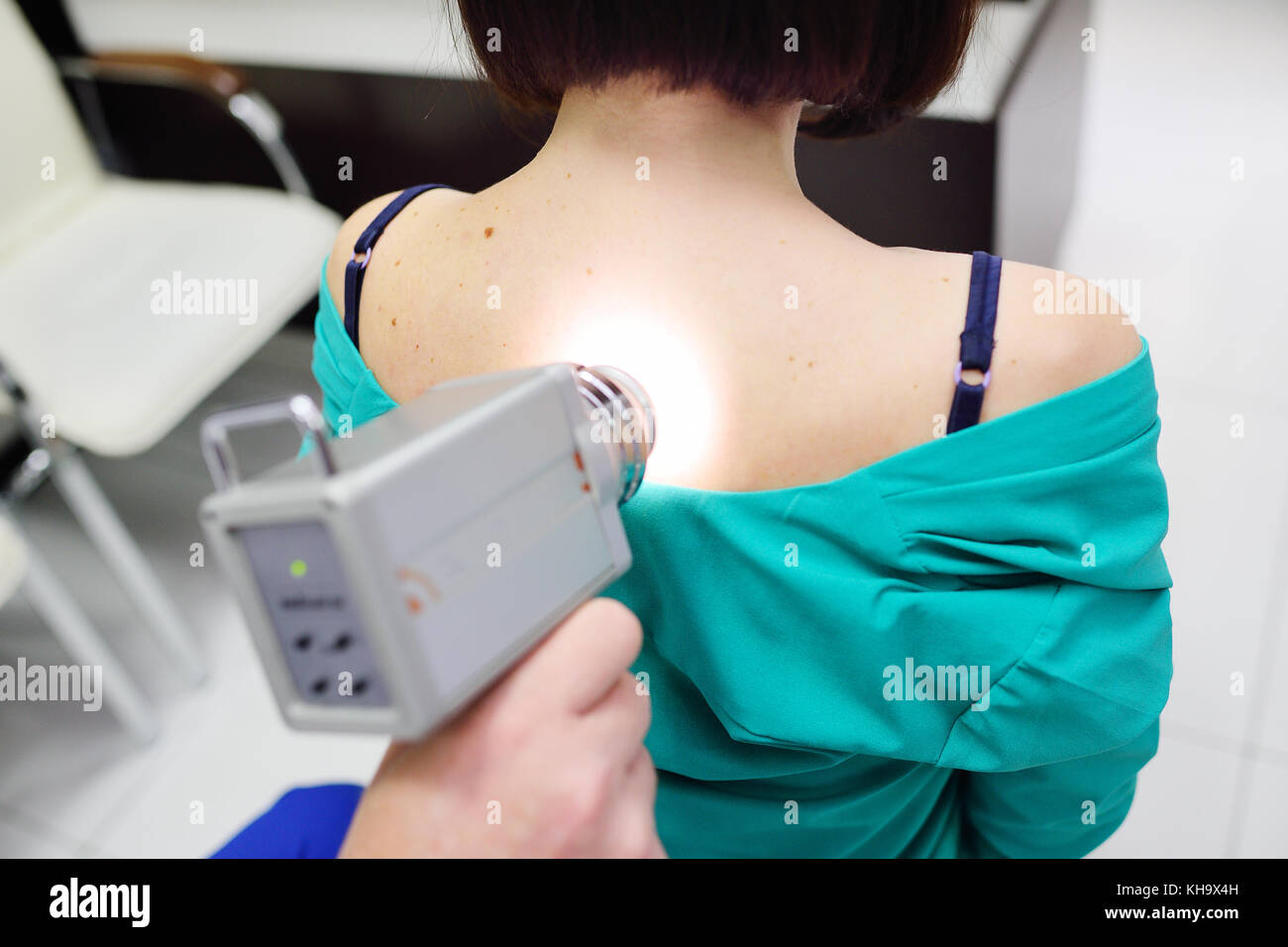 The Doctor Examines Neoplasms Or Moles On The Patients Skin Stock