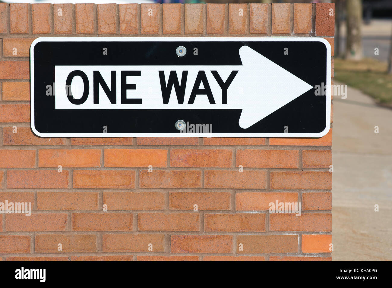 one way street sign affixed to a brick wall Stock Photo - Alamy