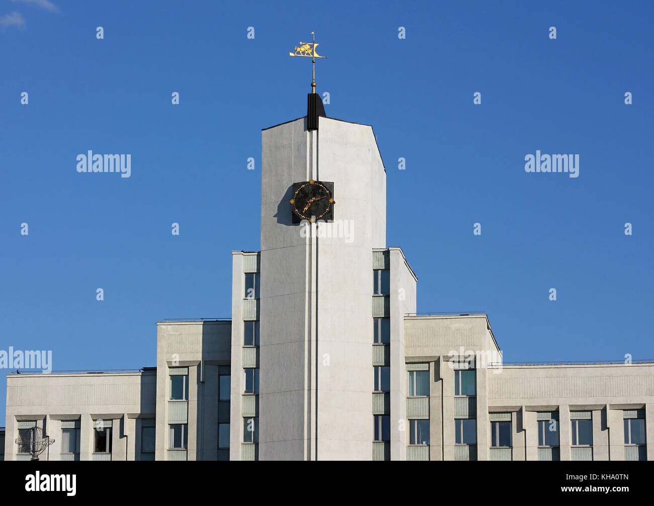 Detail of a white building with a clock tower and the emblem of Belarus ...
