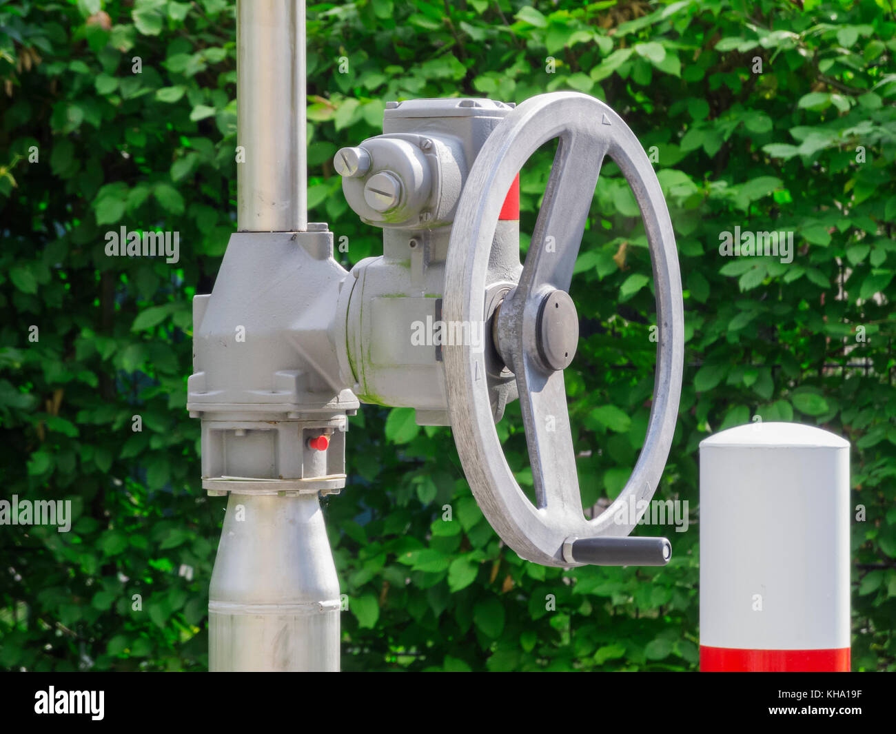 Detail View of a Gray Aluminum Handwheel with Gears in Front of Green ...