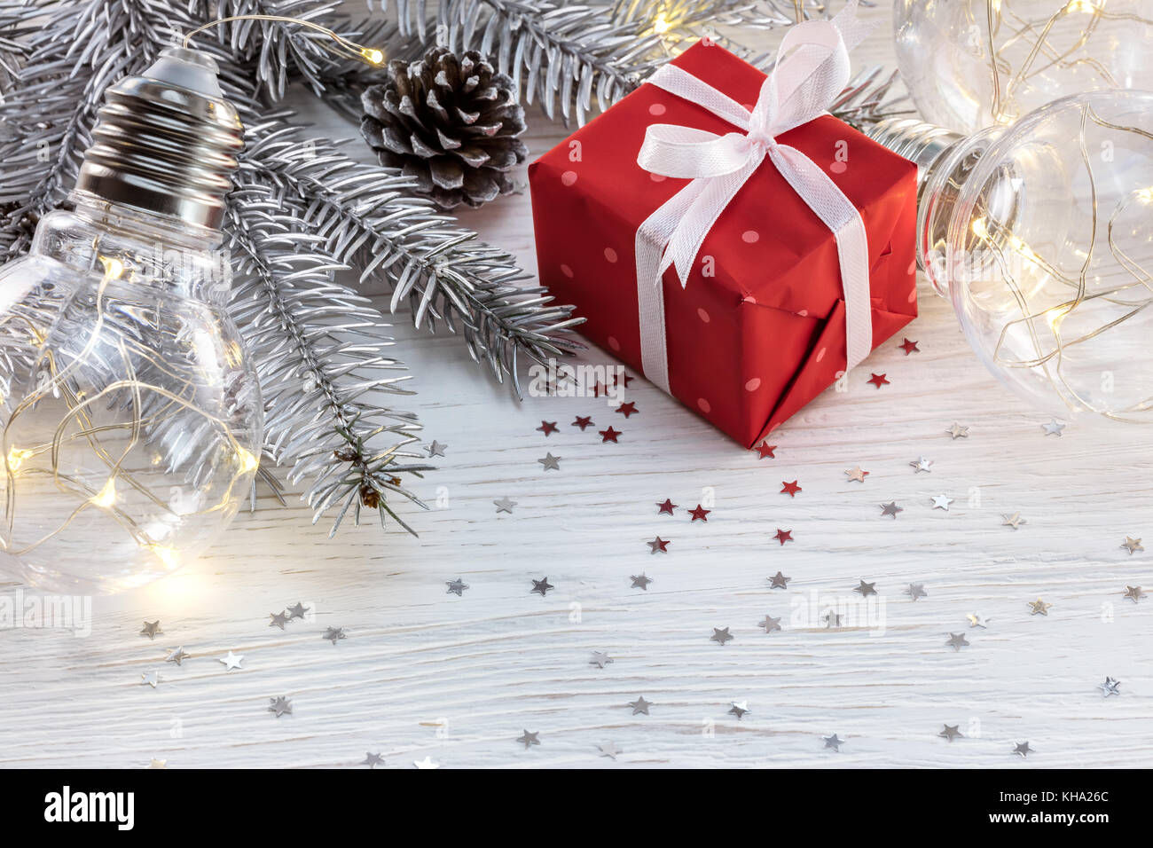 gift box, silver fir tree branch and decorative christmas garland lamps ...