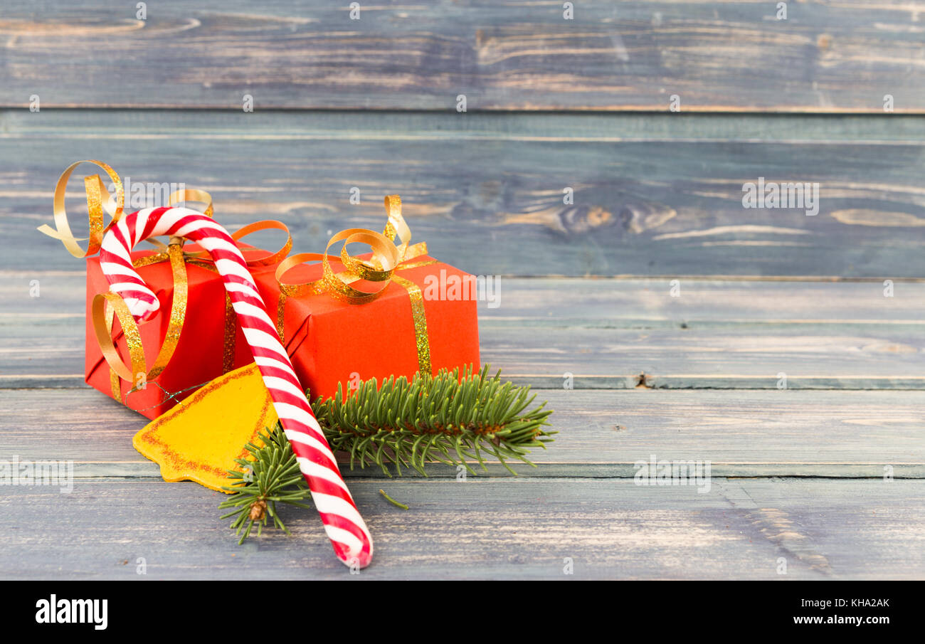 Christmas concept with candy cone and wrapped gifts on wood background ...