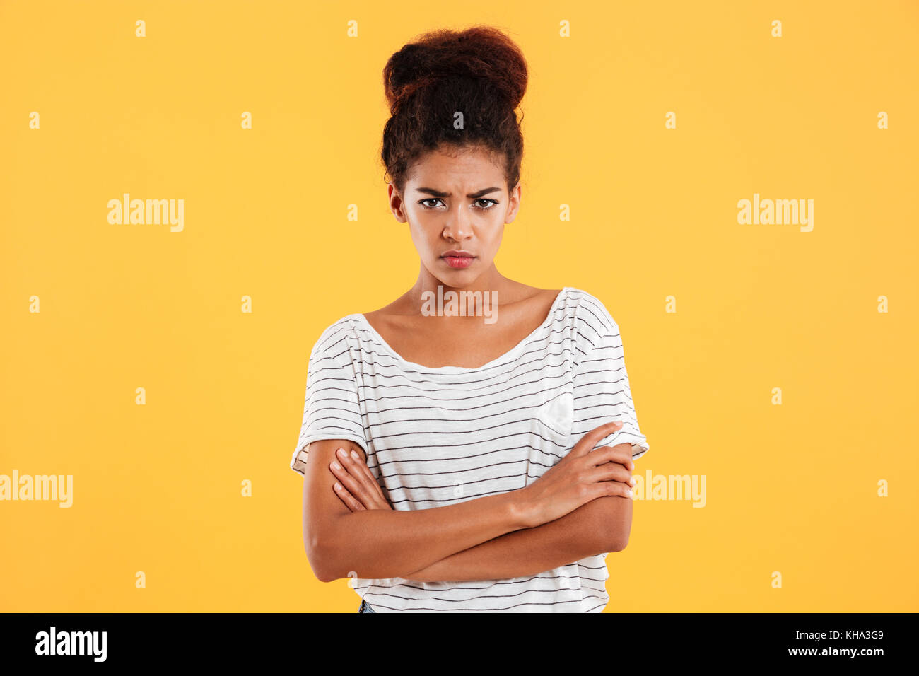Portrait of angry displeased african lady in white pullover holding ...