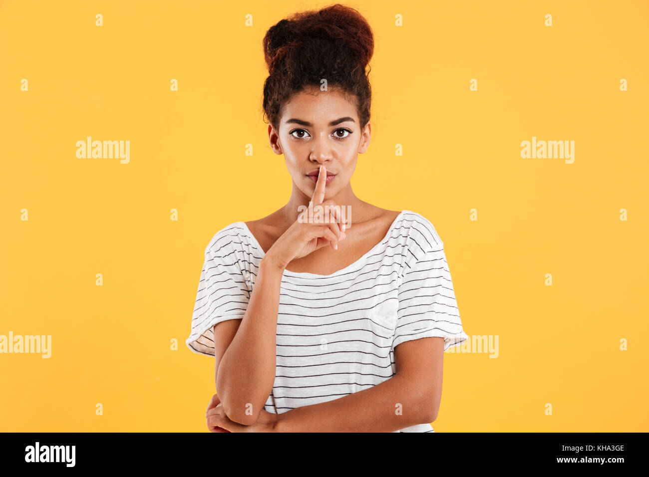 Portrait of serious calm confident woman showing silence gesture and ...