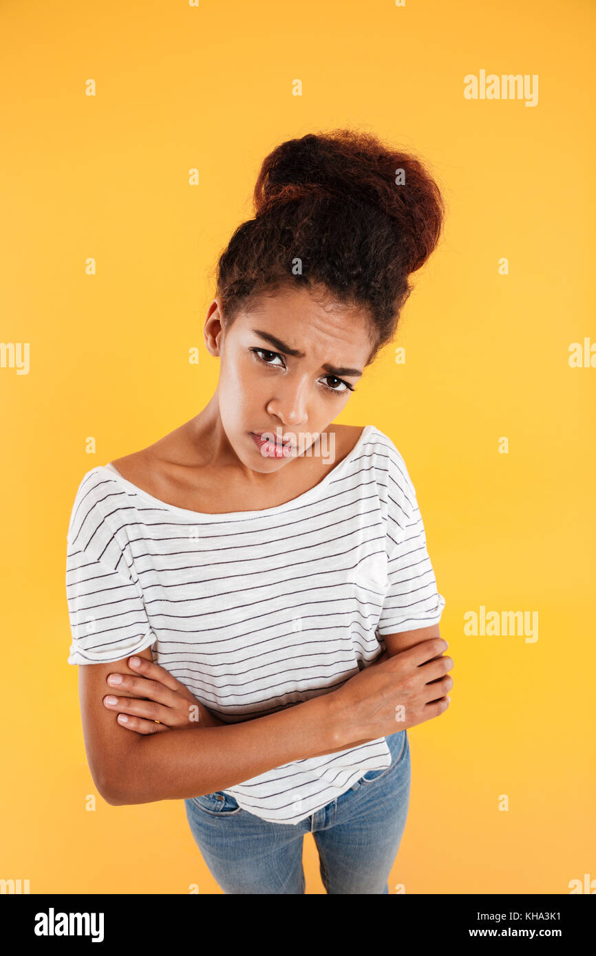 Top view of young african puzzled displeased lady looking up at camera ...