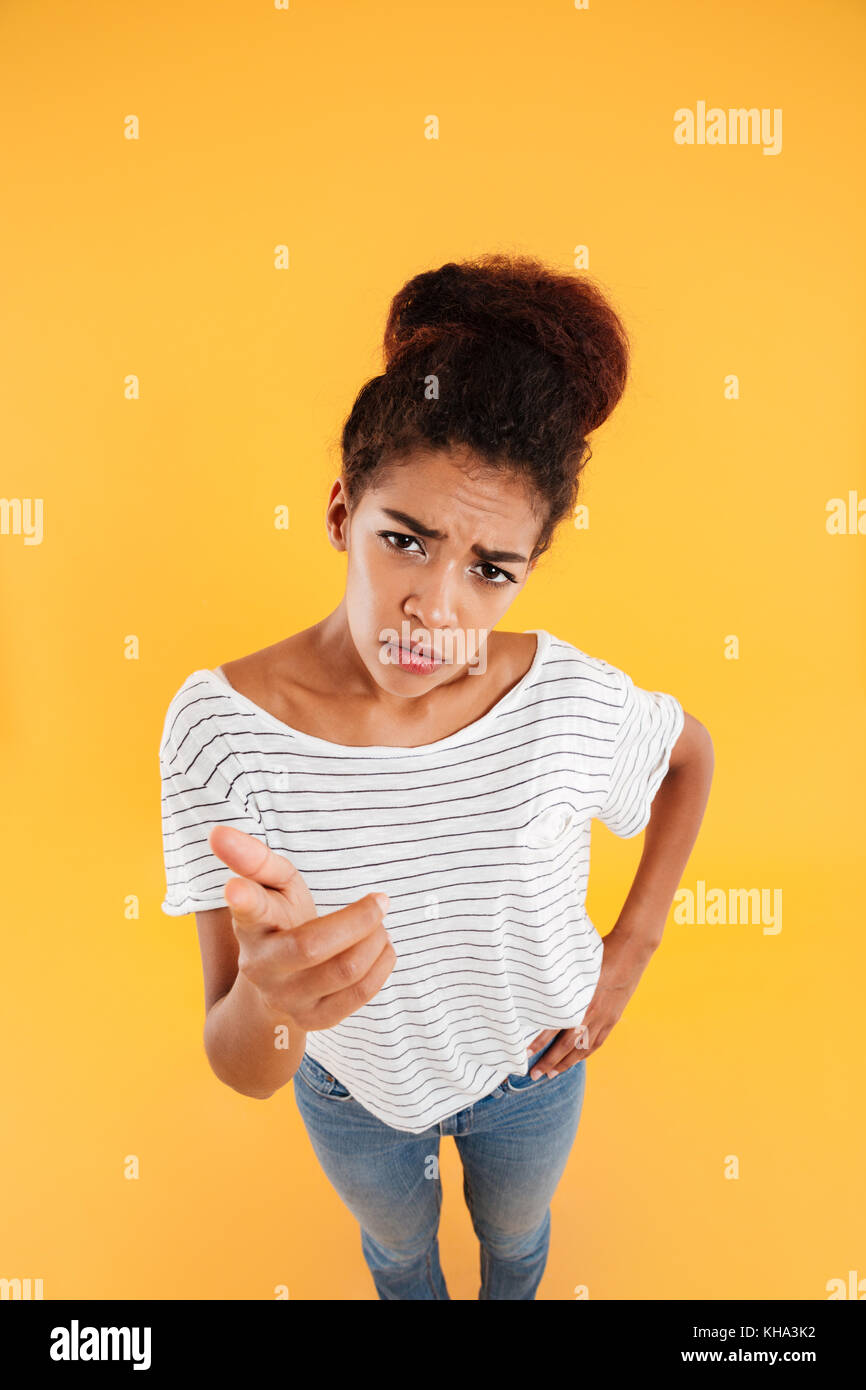 Top view of young african puzzled displeased lady looking up at camera ...