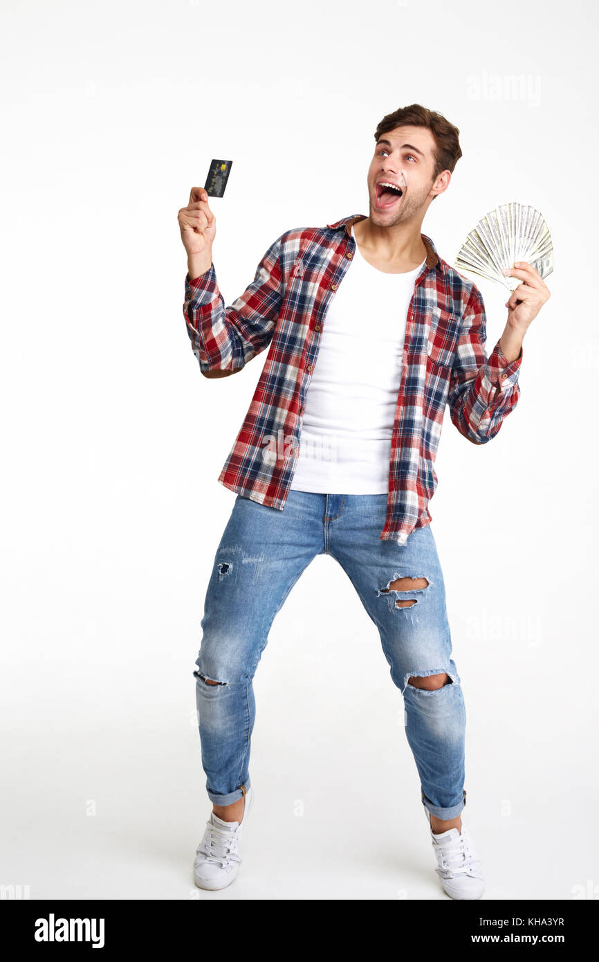 Full length portrait of a happy smiling man holding bunch of money ...
