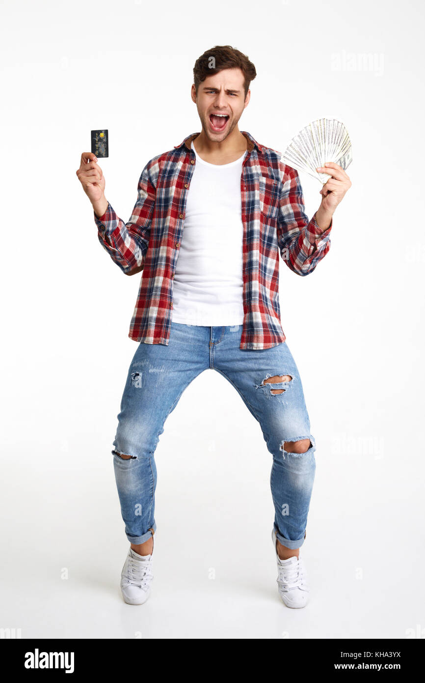 Full length portrait of a happy excited man holding bunch of money ...