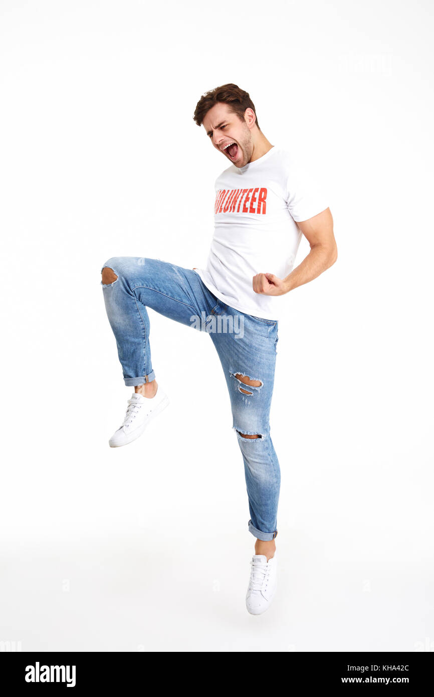 Full length portrait of a happy amused man in volunteer t-shirt ...