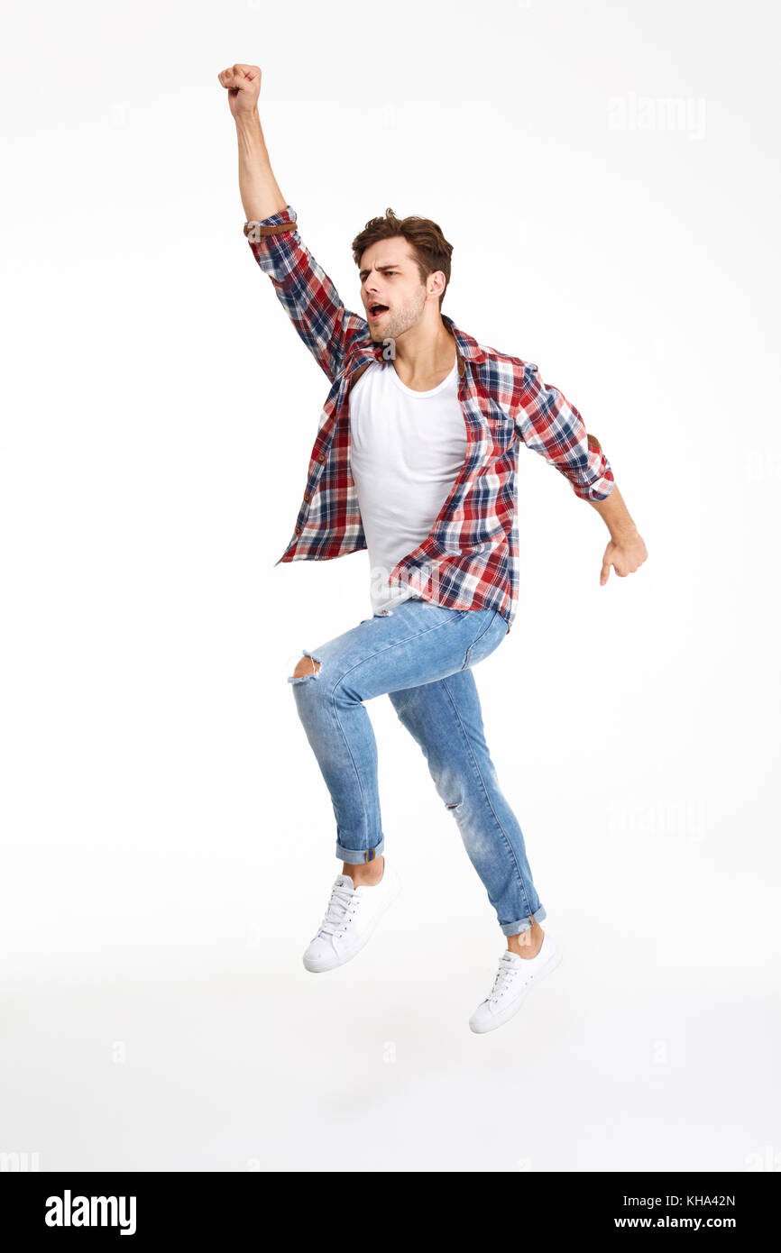 Full length portrait of a casual attractive man jumping with hand ...