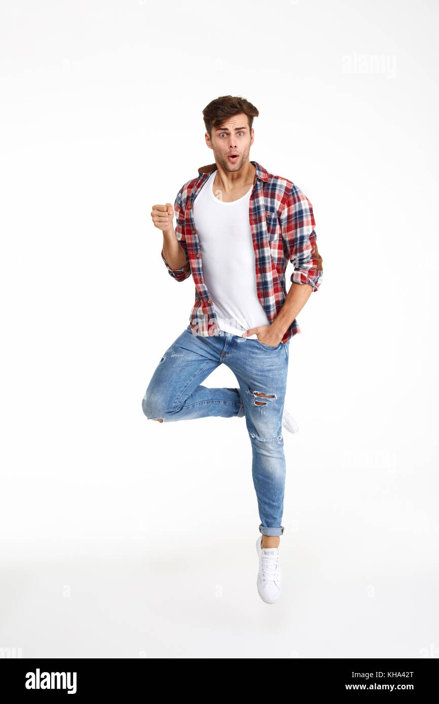 Full length portrait of a funny casual man jumping and holding ...
