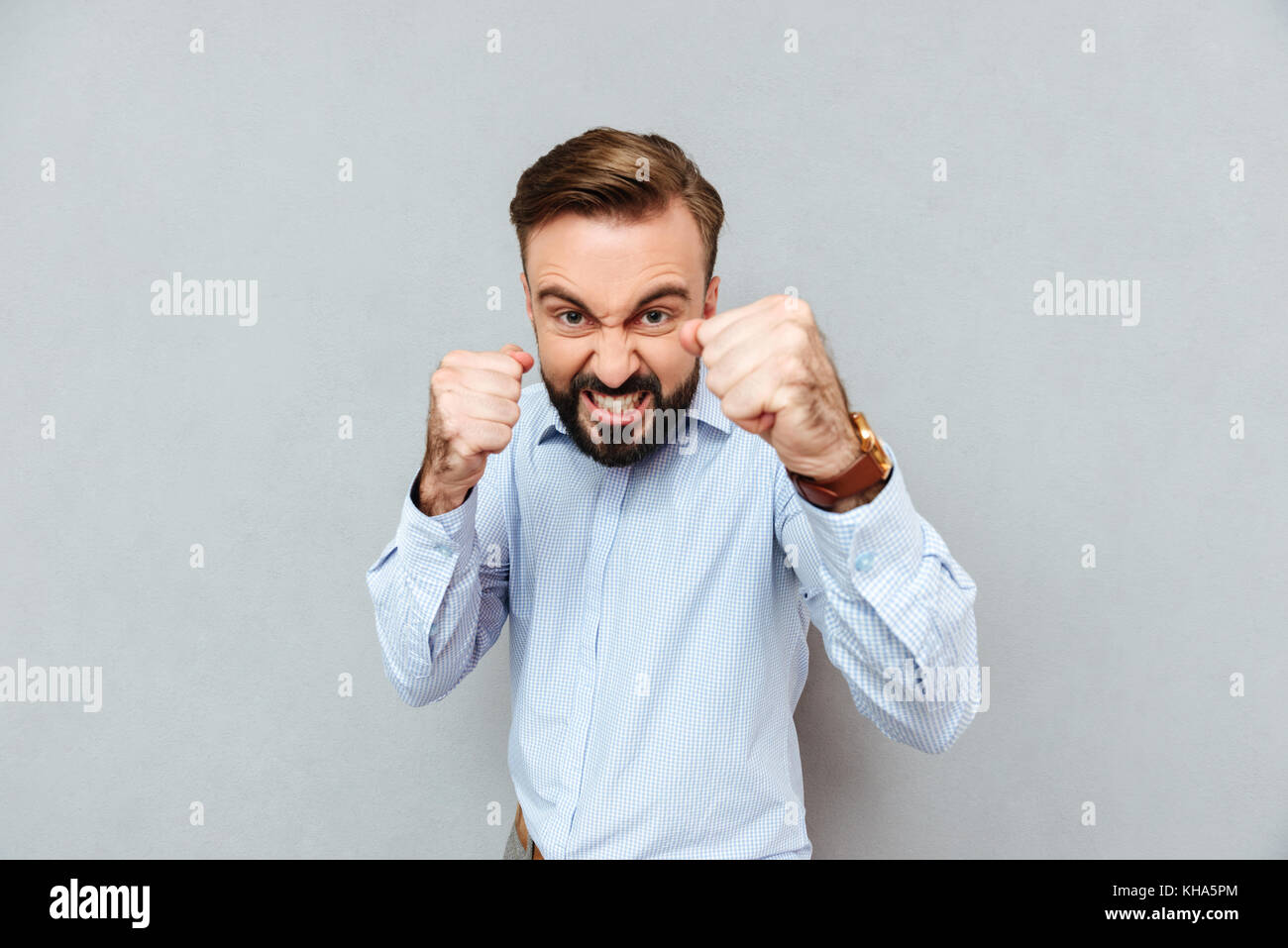 Angry bearded man in business clothes ready to fight and looking at the ...
