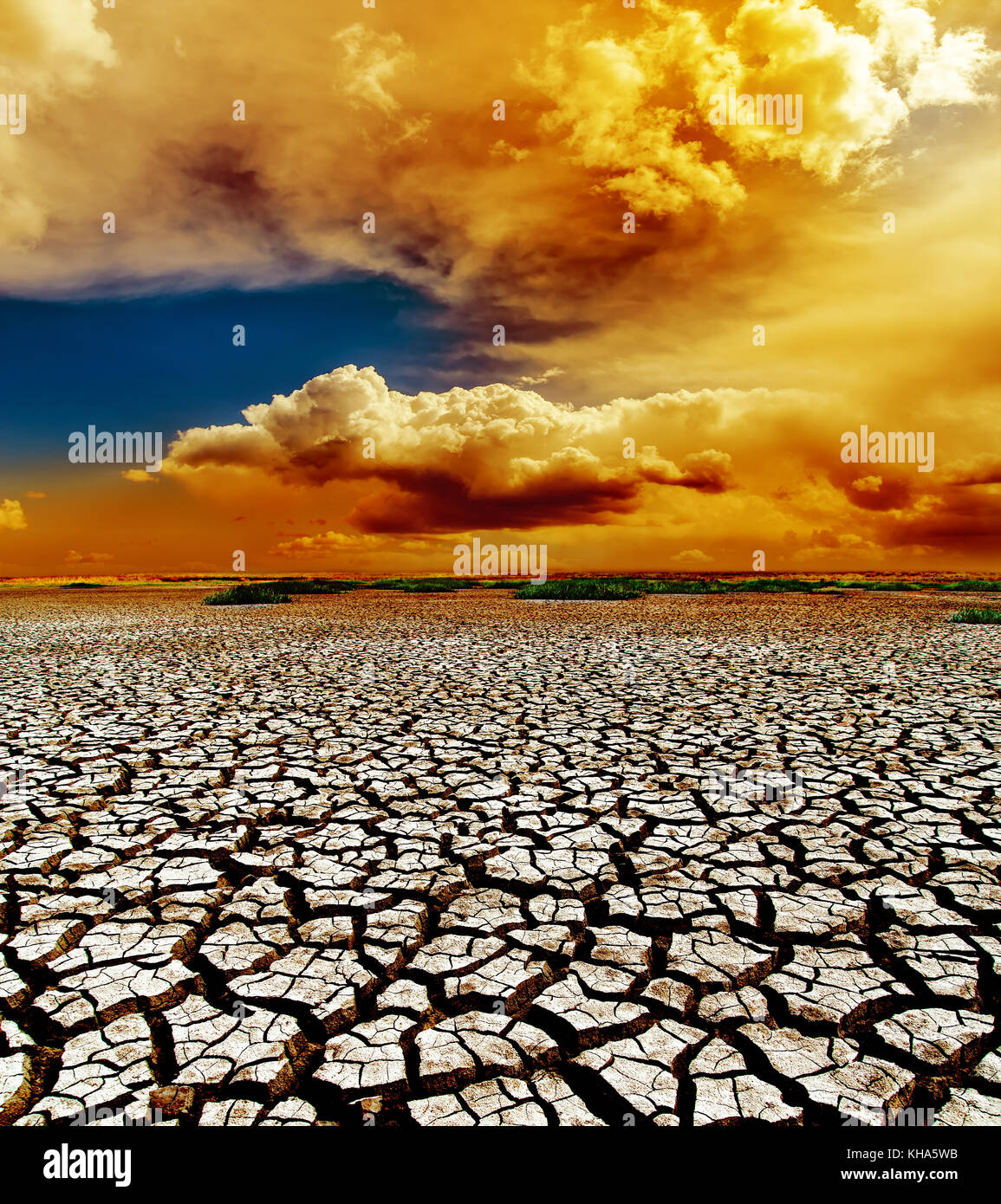 dramatic sunset over dry cracked earth Stock Photo - Alamy