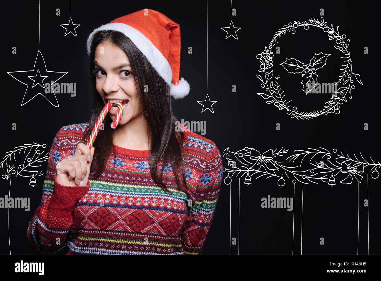 Joyful young girl eating the candy stick in the studio Stock Photo - Alamy