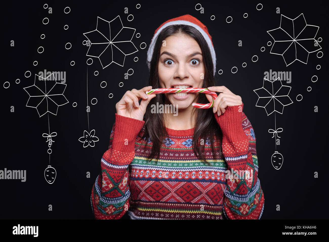 Funny girl eating the candy stick and having fun Stock Photo - Alamy
