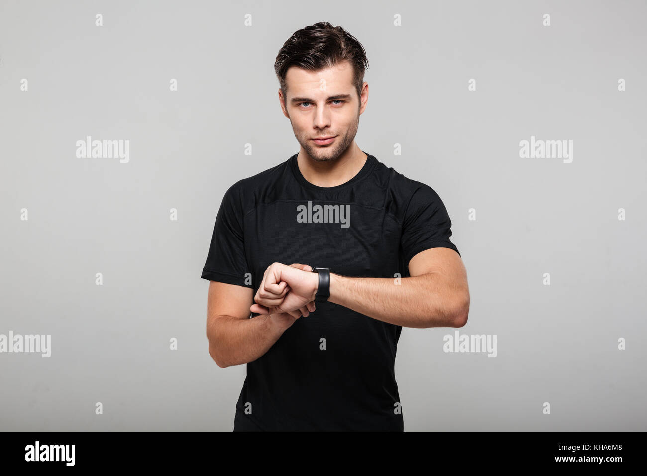 Young man looking adjusting watch hi-res stock photography and images ...