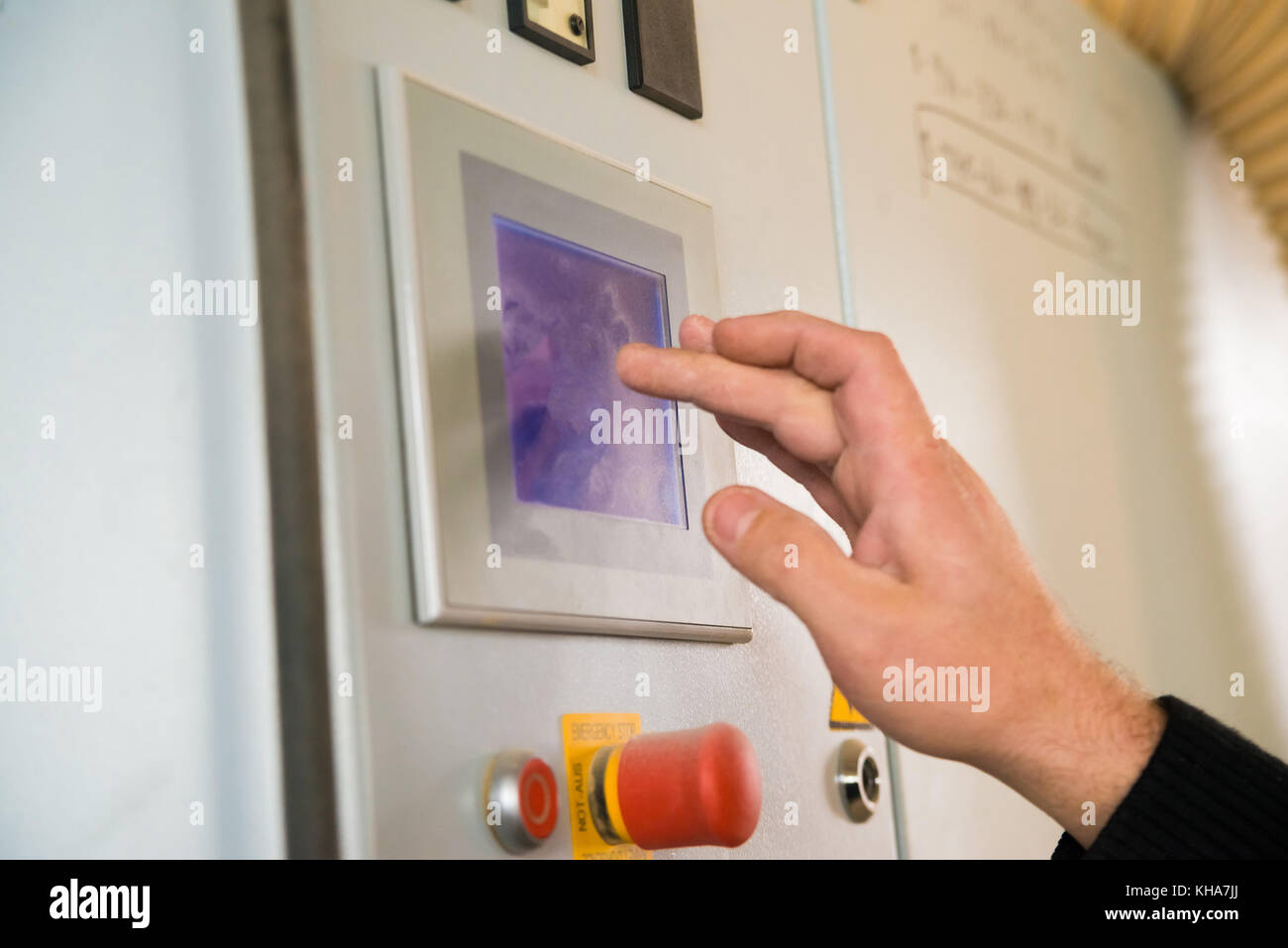 Close up male hand pressing touch screen of a device in joinery Stock ...