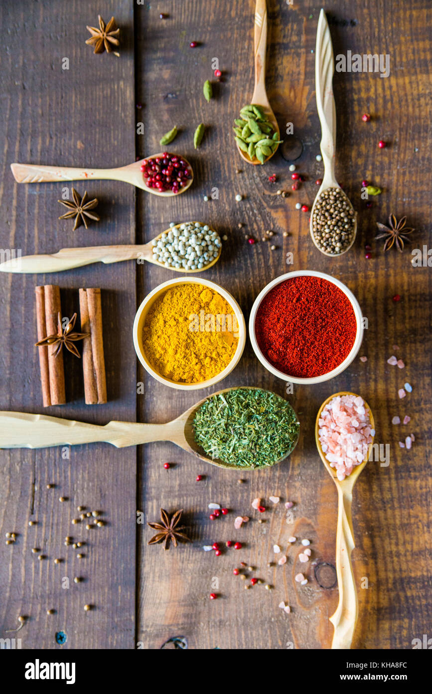 Various colorful herbs and spices on wooden table Stock Photo - Alamy