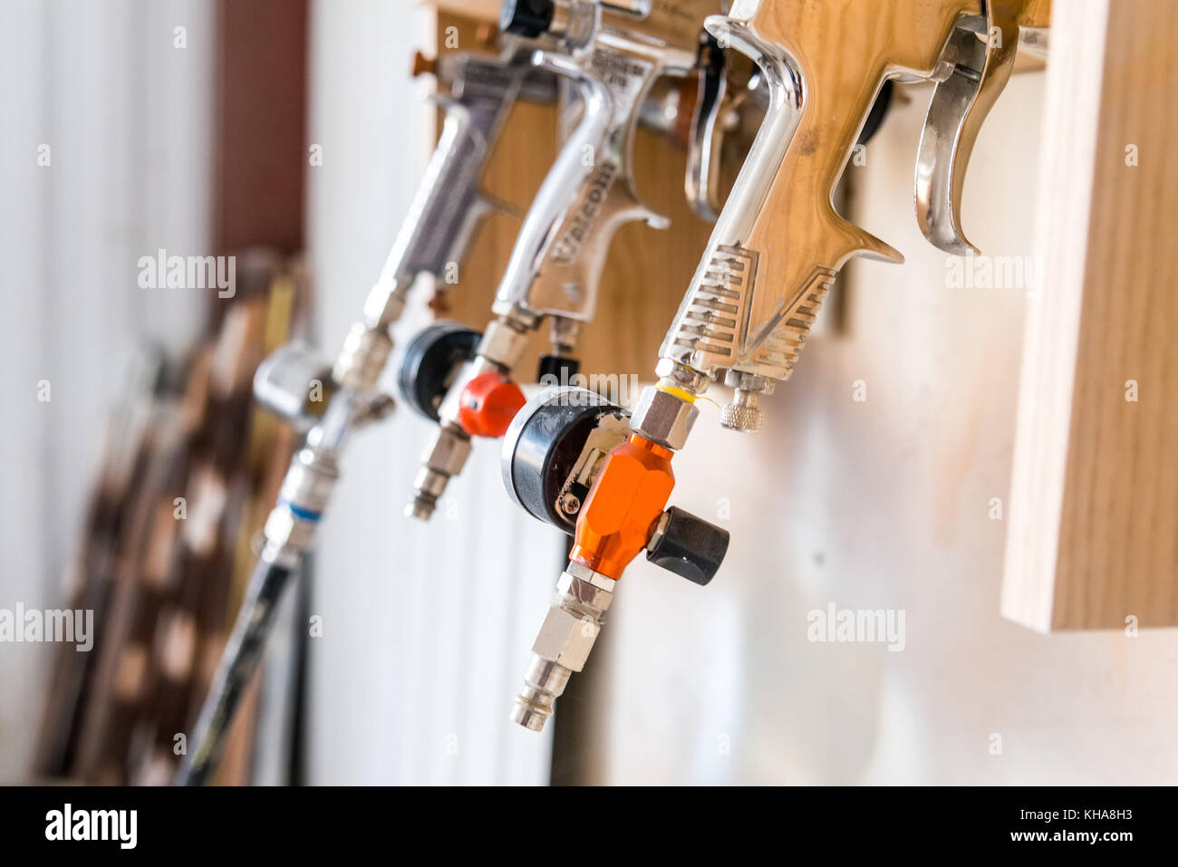 Spray guns in woodworking workshop Stock Photo - Alamy