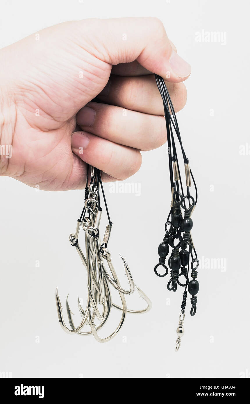 Hand holding a bunch of fishing hook link ready made, tied on the steel ...