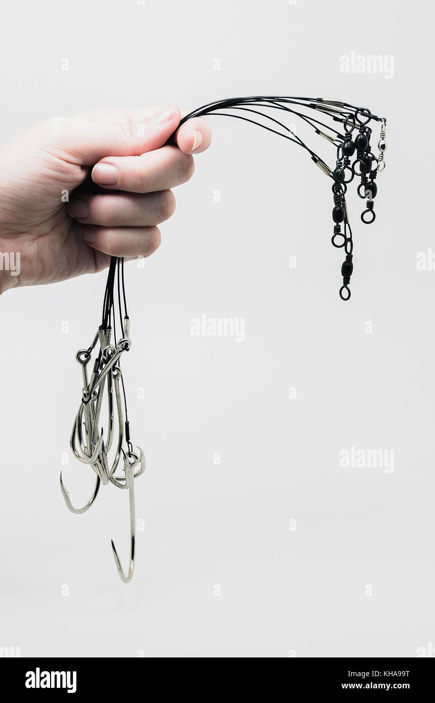 Hand holding a bunch of fishing hook link ready made, tied on the steel ...