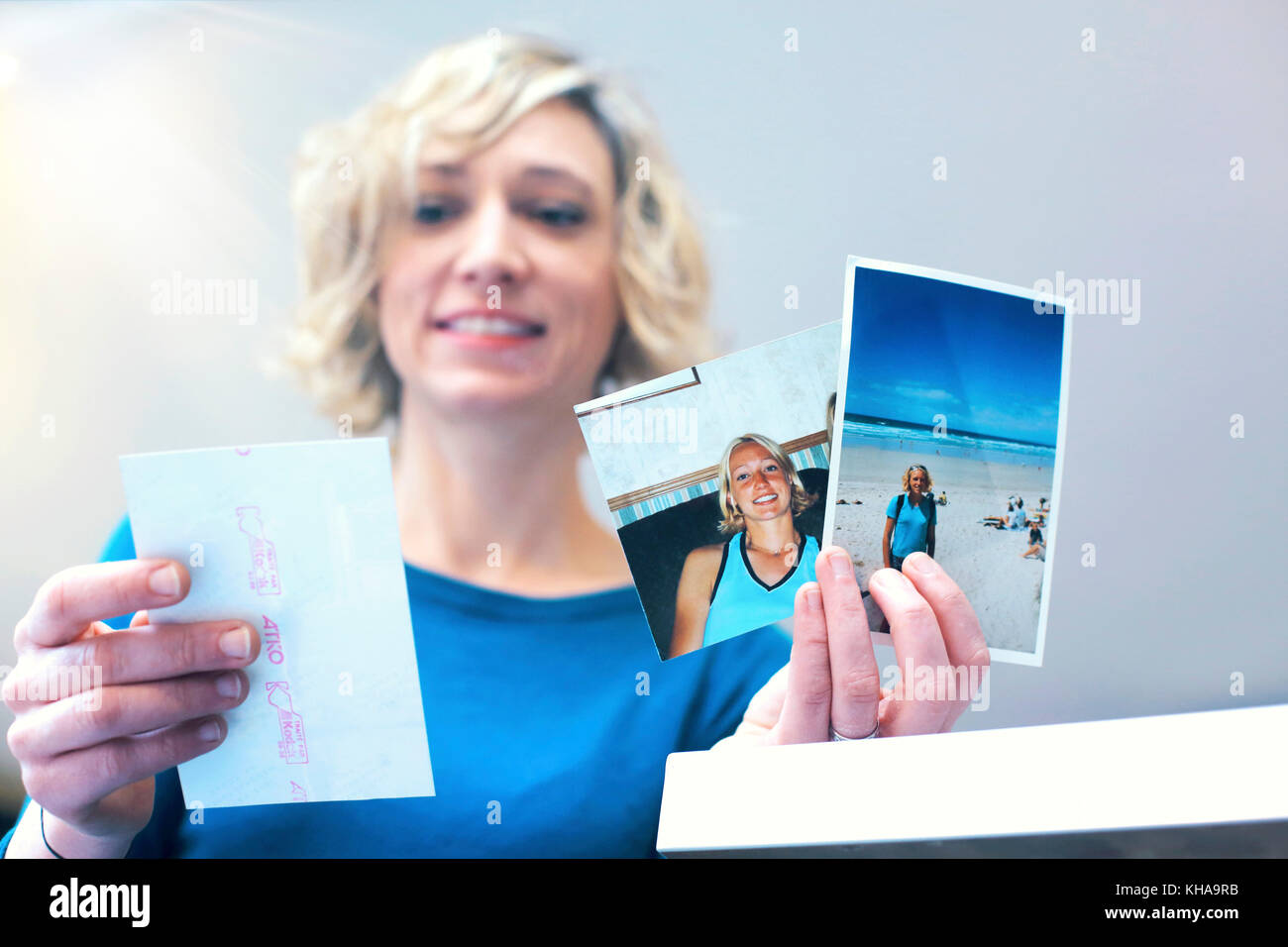 Woman at home looking at pictures Stock Photo - Alamy
