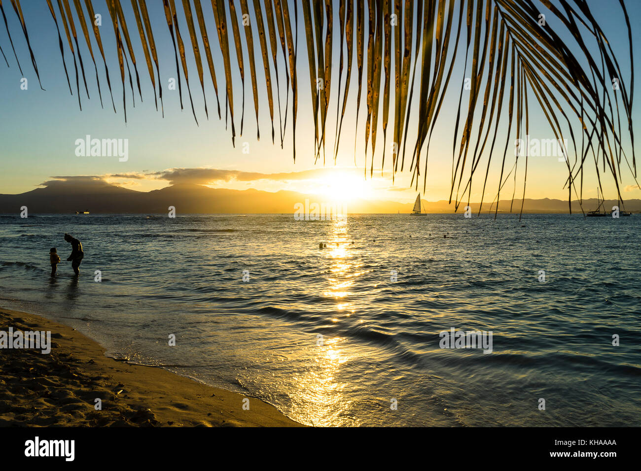People on the beach at the sunset, Gosier island, Guadeloupe, France ...