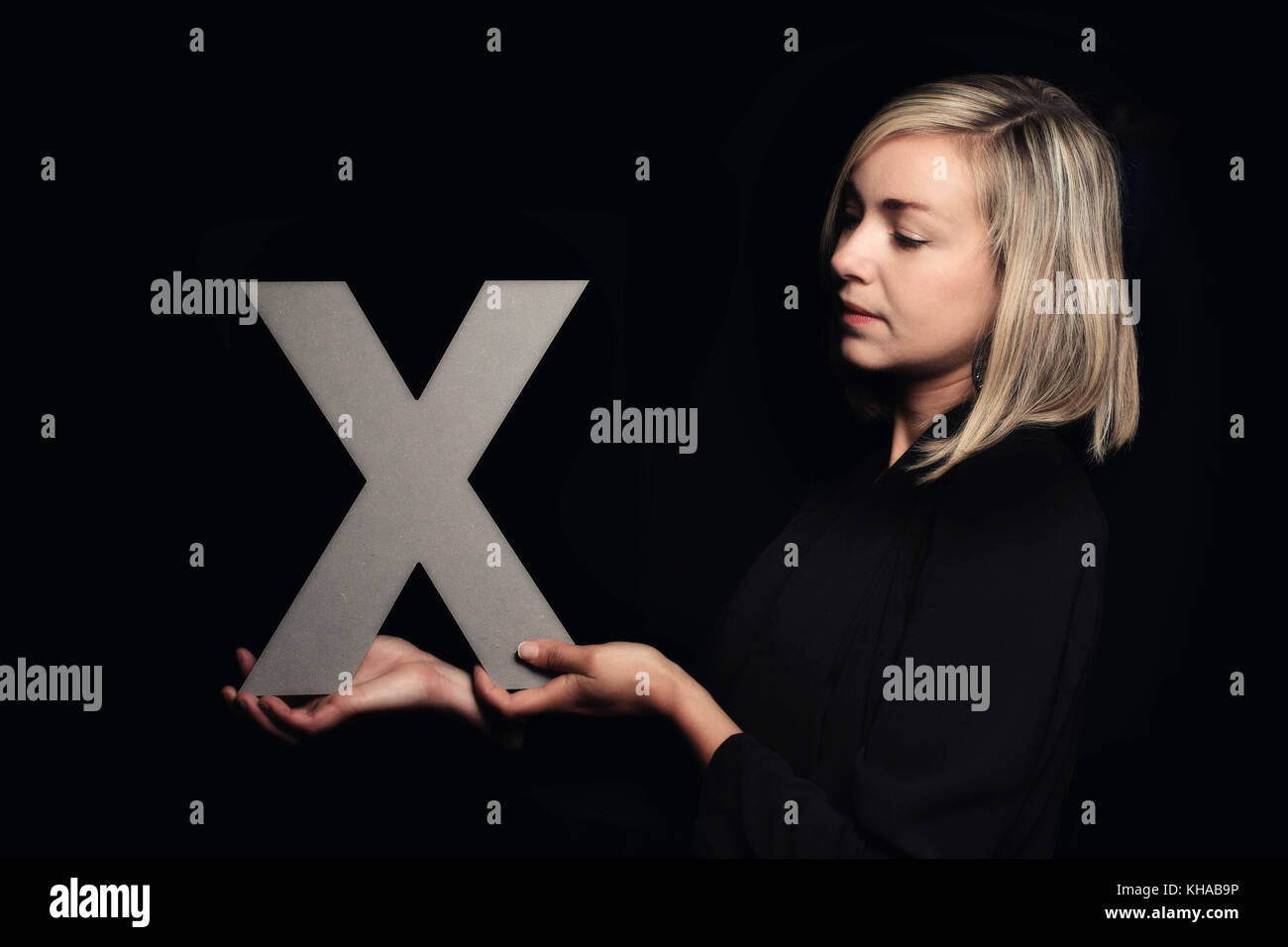 Young woman with X letter Stock Photo - Alamy