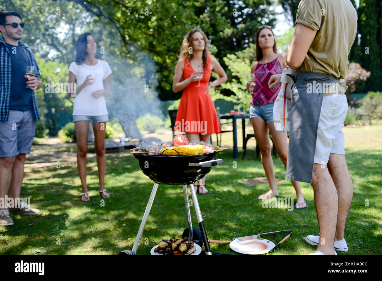 Groupe of happy and cheerful young people having fun around barbecue ...