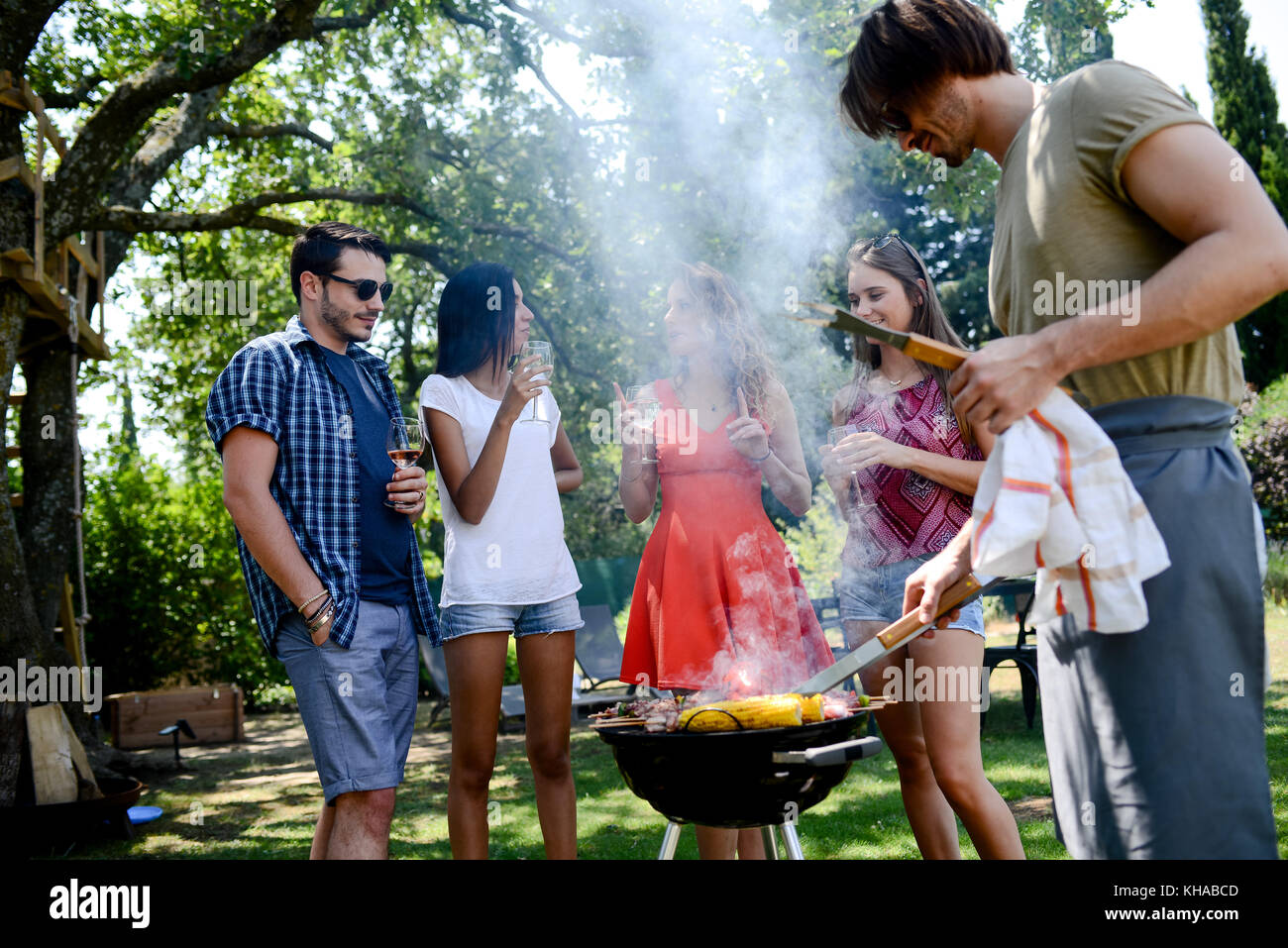 Groupe of happy and cheerful young people having fun around barbecue ...
