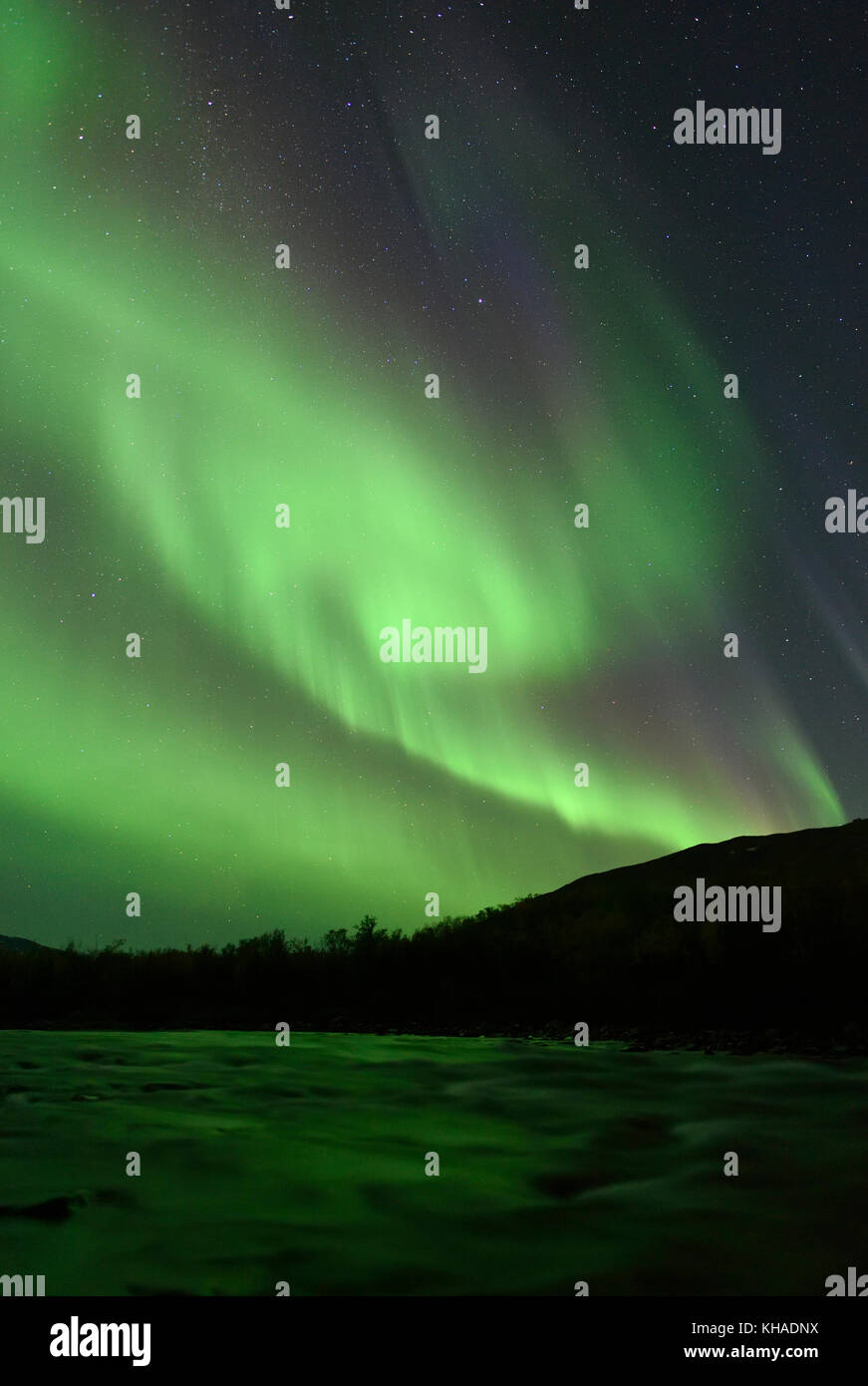 Northern lights over the river Aisko in Abisko National Park, Sweden ...