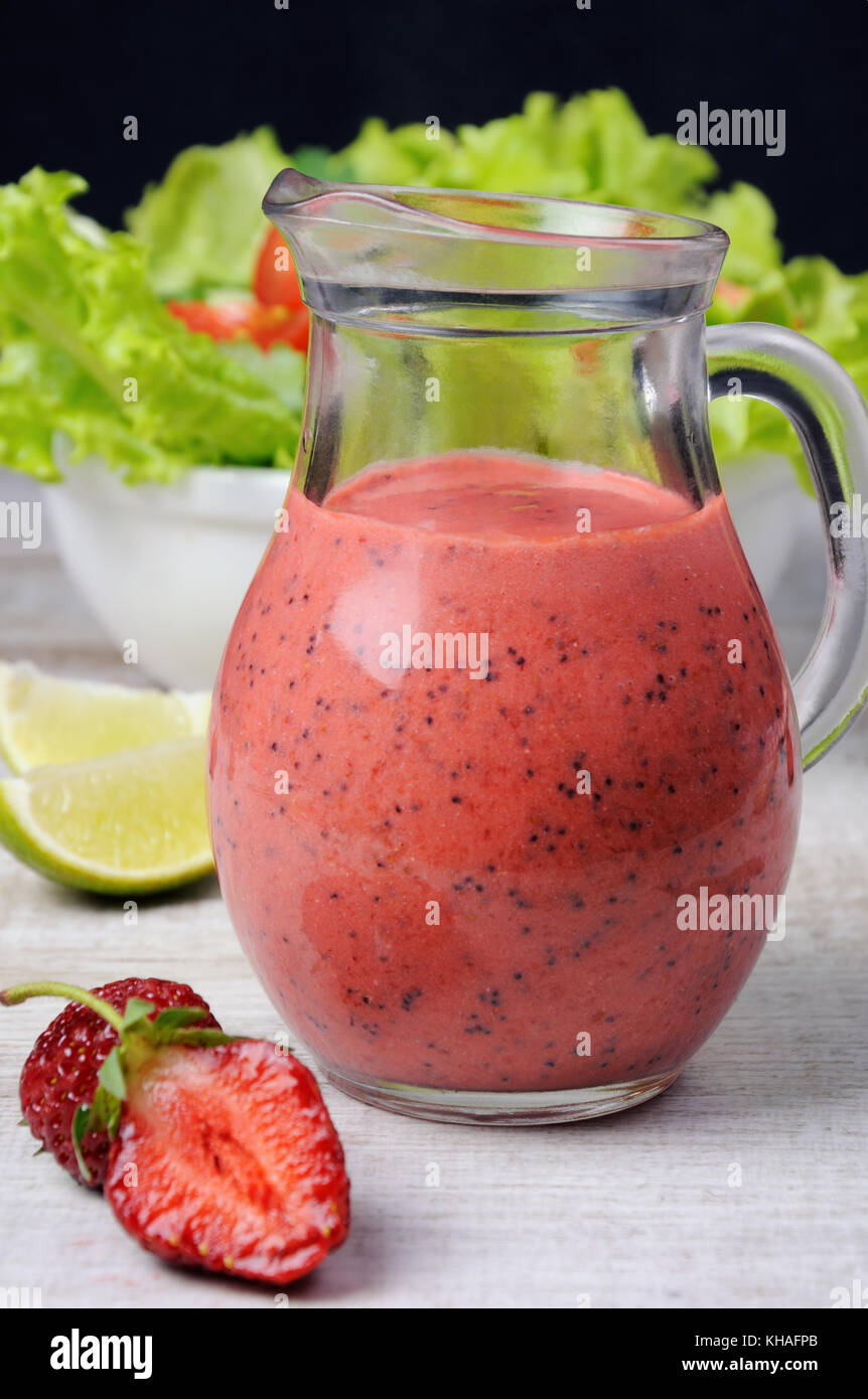 Strawberry fresh sauce with mint, poppy and lime in a glass sauceboat ...