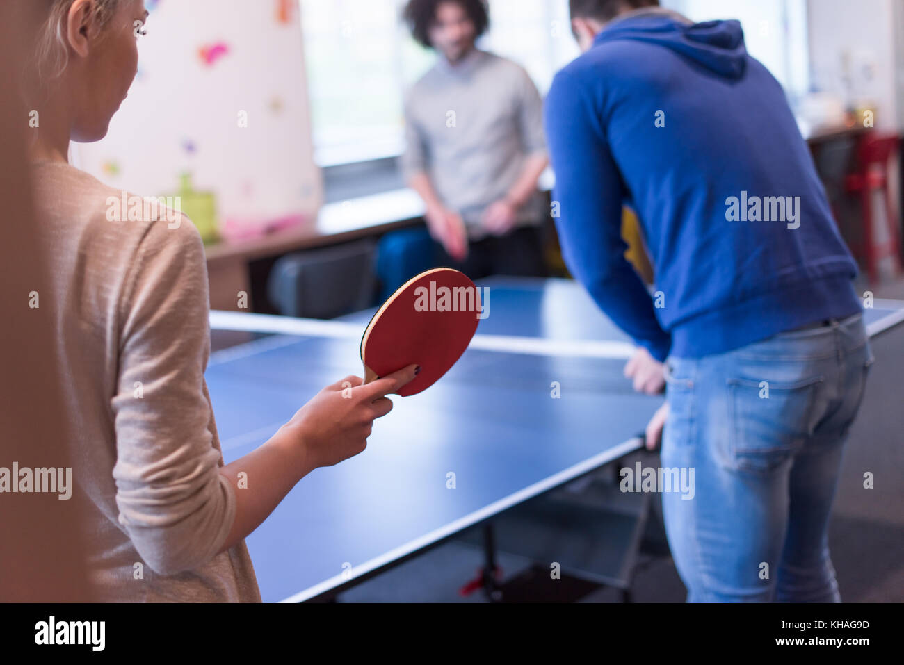 group of young startup business people playing ping pong tennis at ...