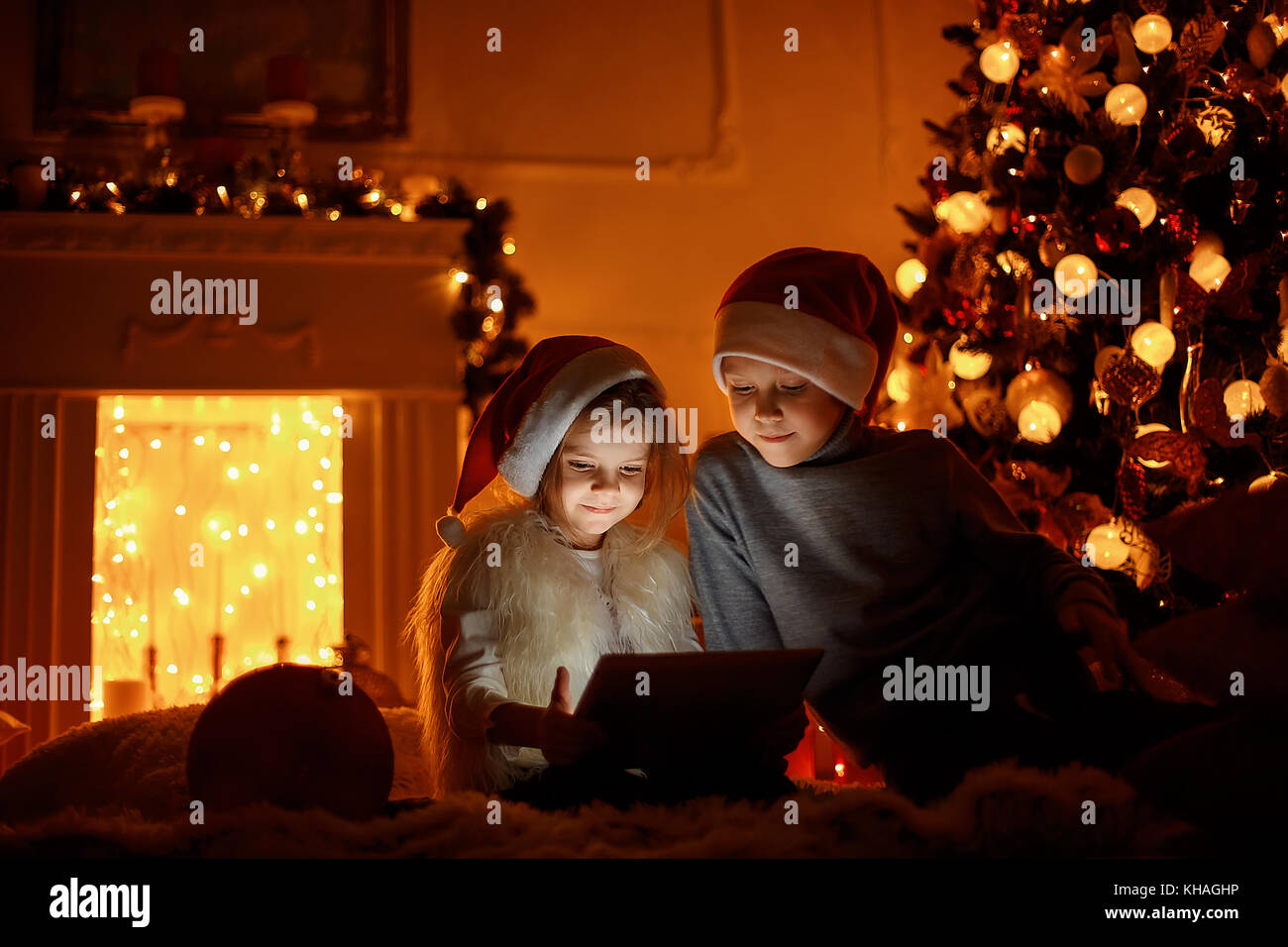 Excited children near Christmas tree Stock Photo - Alamy