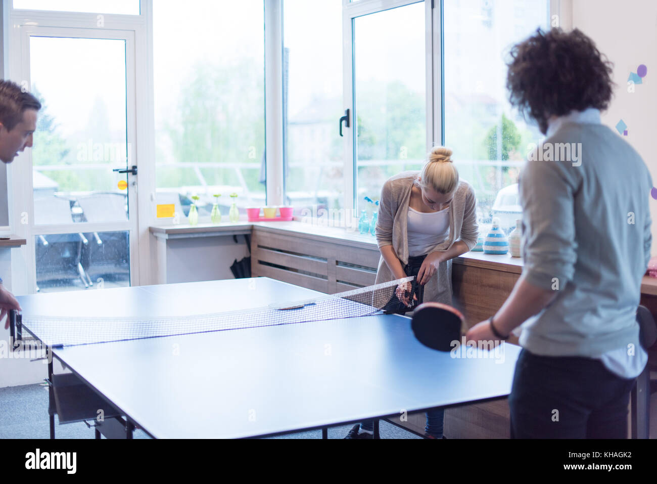 group of young startup business people playing ping pong tennis at ...