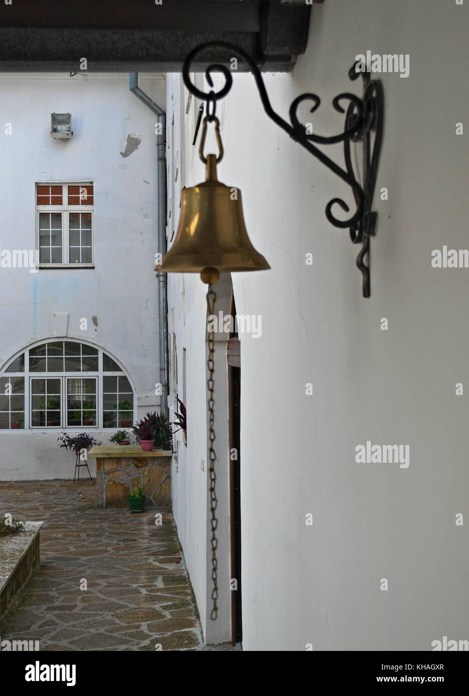 Bell hanging on wall Stock Photo - Alamy
