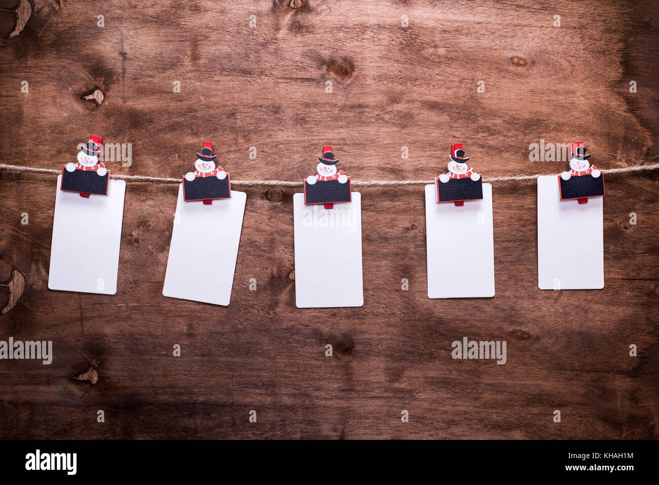 white paper tags hanging on a rope hooked on decorative christmas ...