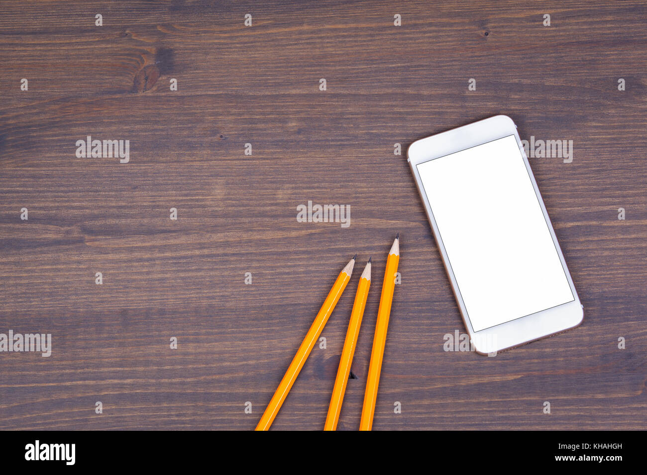 Top view of smart phone on wooden background Stock Photo - Alamy