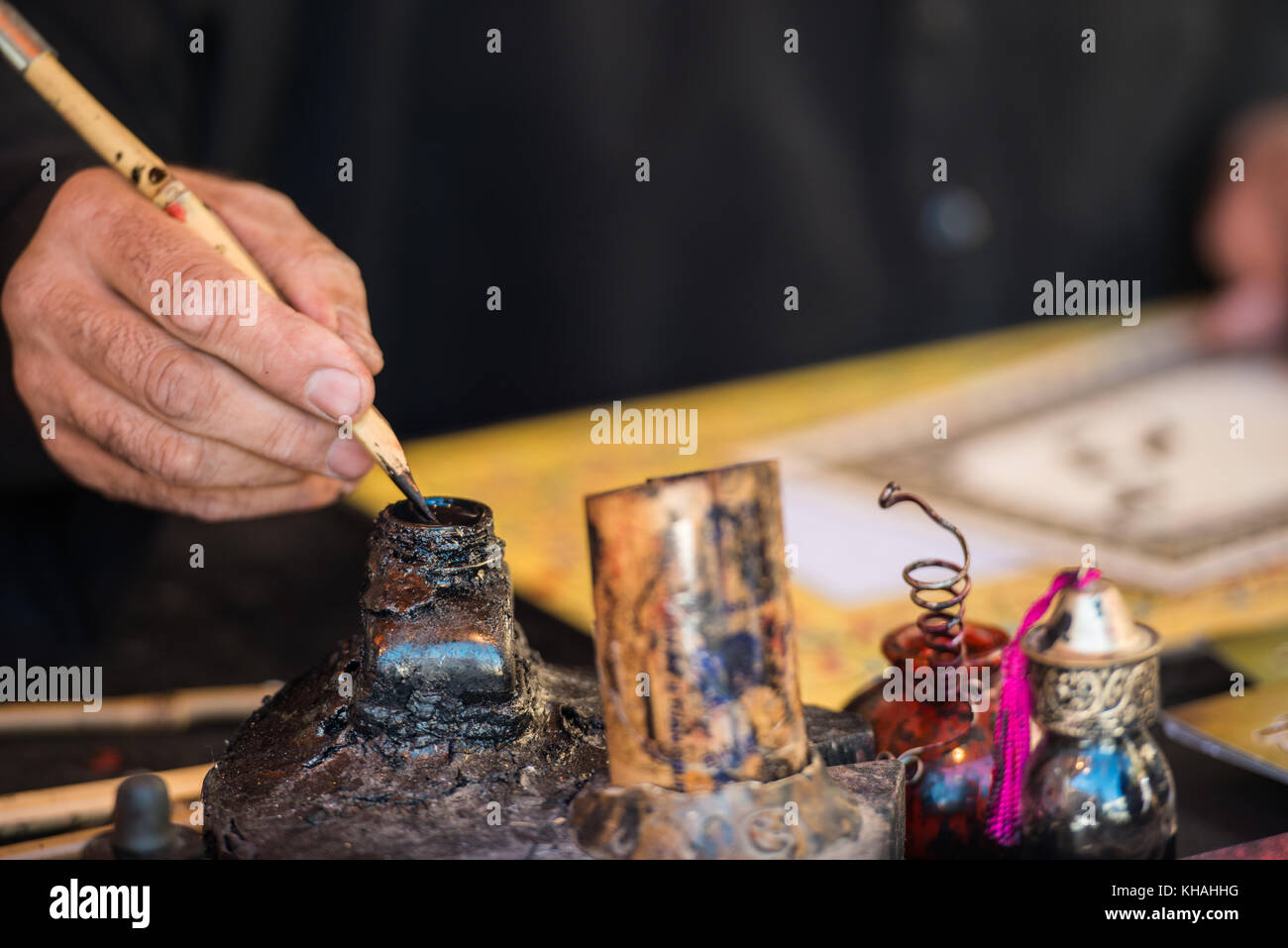 The hands of an old man writing letters with Arabic spelling Stock ...