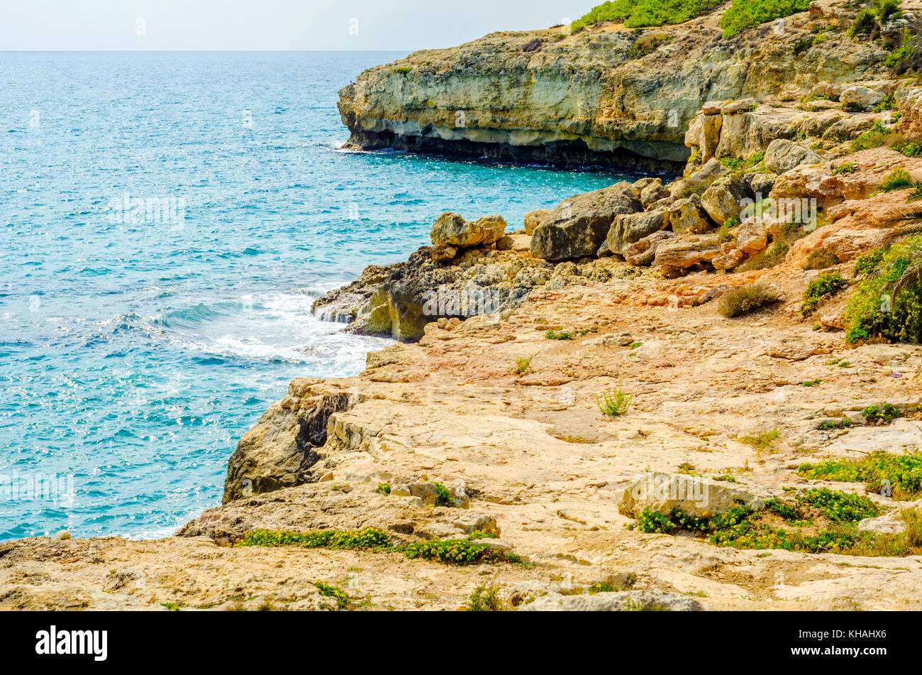 high cliff above the sea, summer sea background, many splashing waves ...