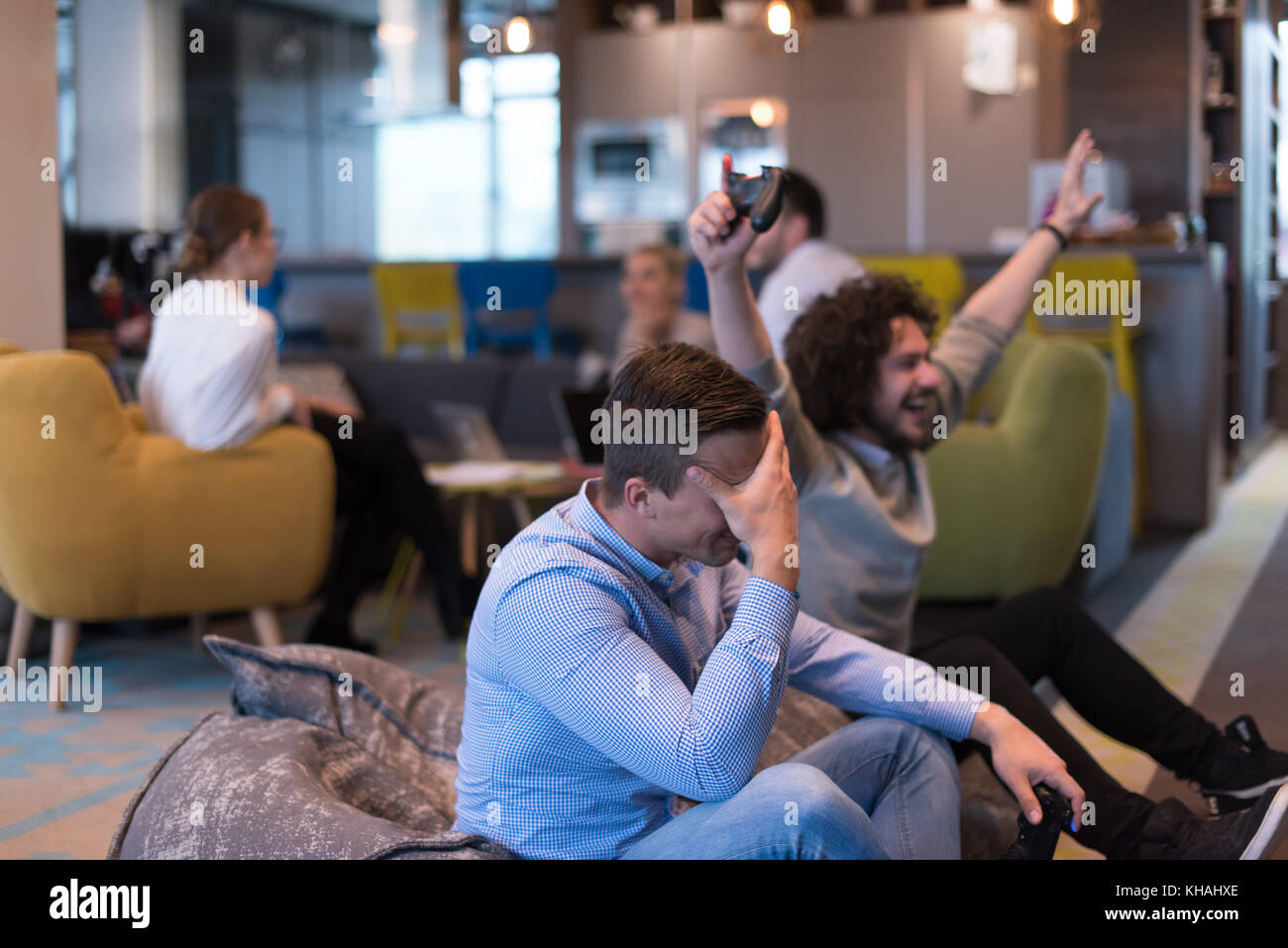 Work hard play hard. Workers Playing computer games in creative startup ...