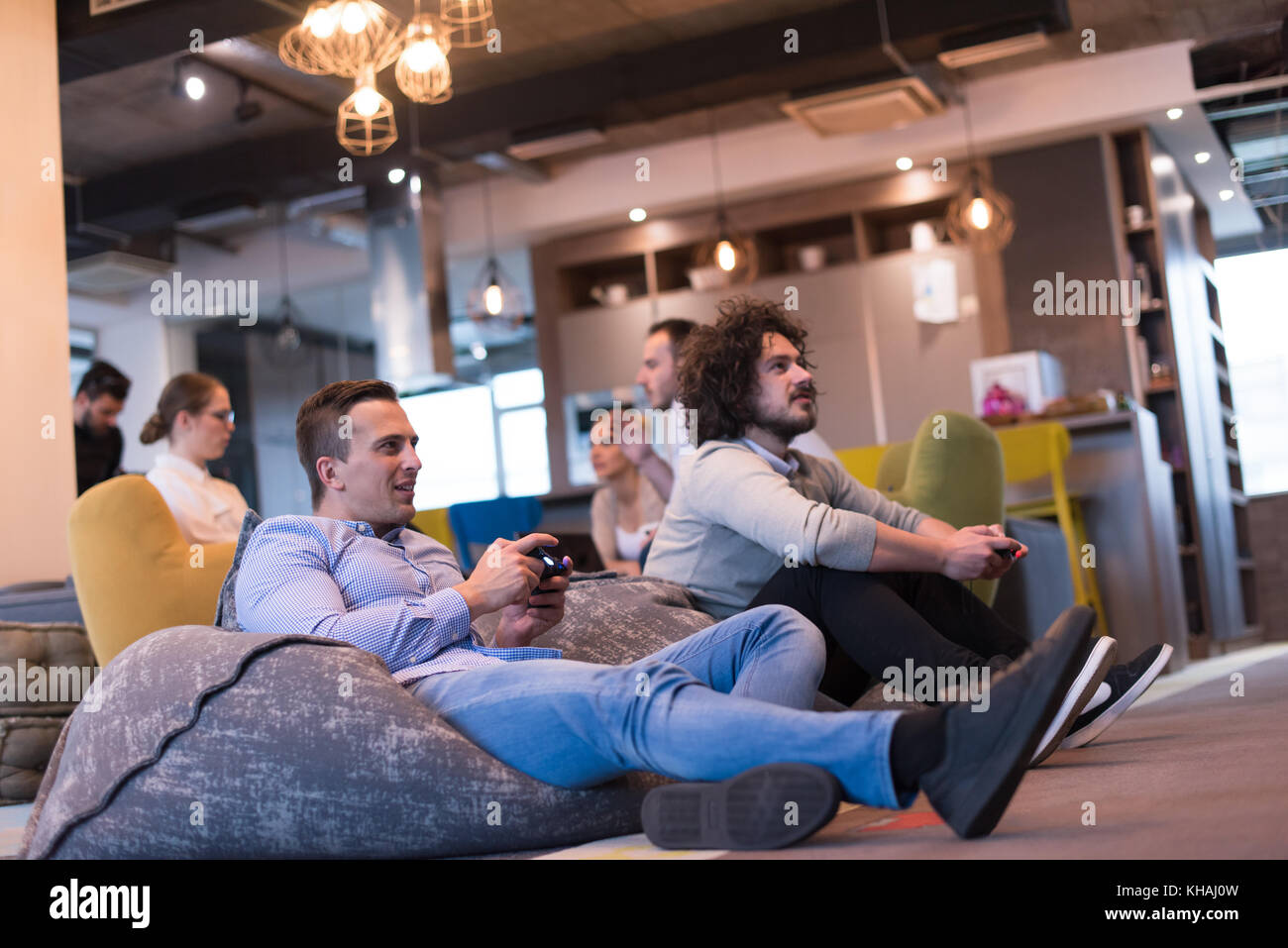 Work hard play hard. Workers Playing computer games in creative startup ...