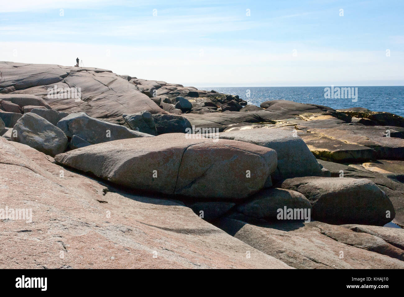 Photographer at rocks in Peggy's Cove, Nova Scotia Stock Photo - Alamy