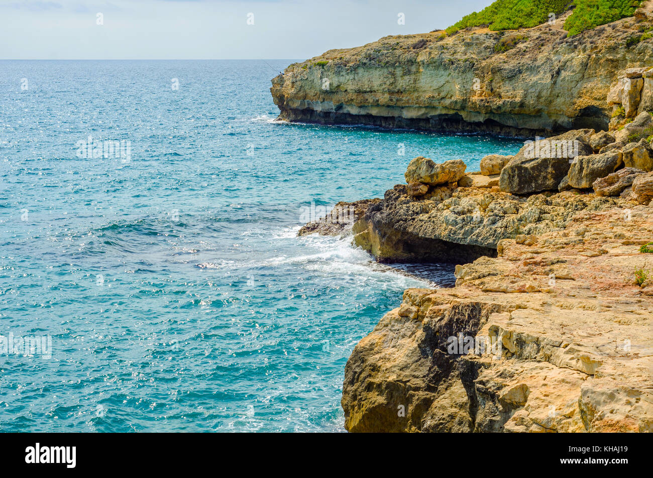 high cliff above the sea, summer sea background, many splashing waves ...