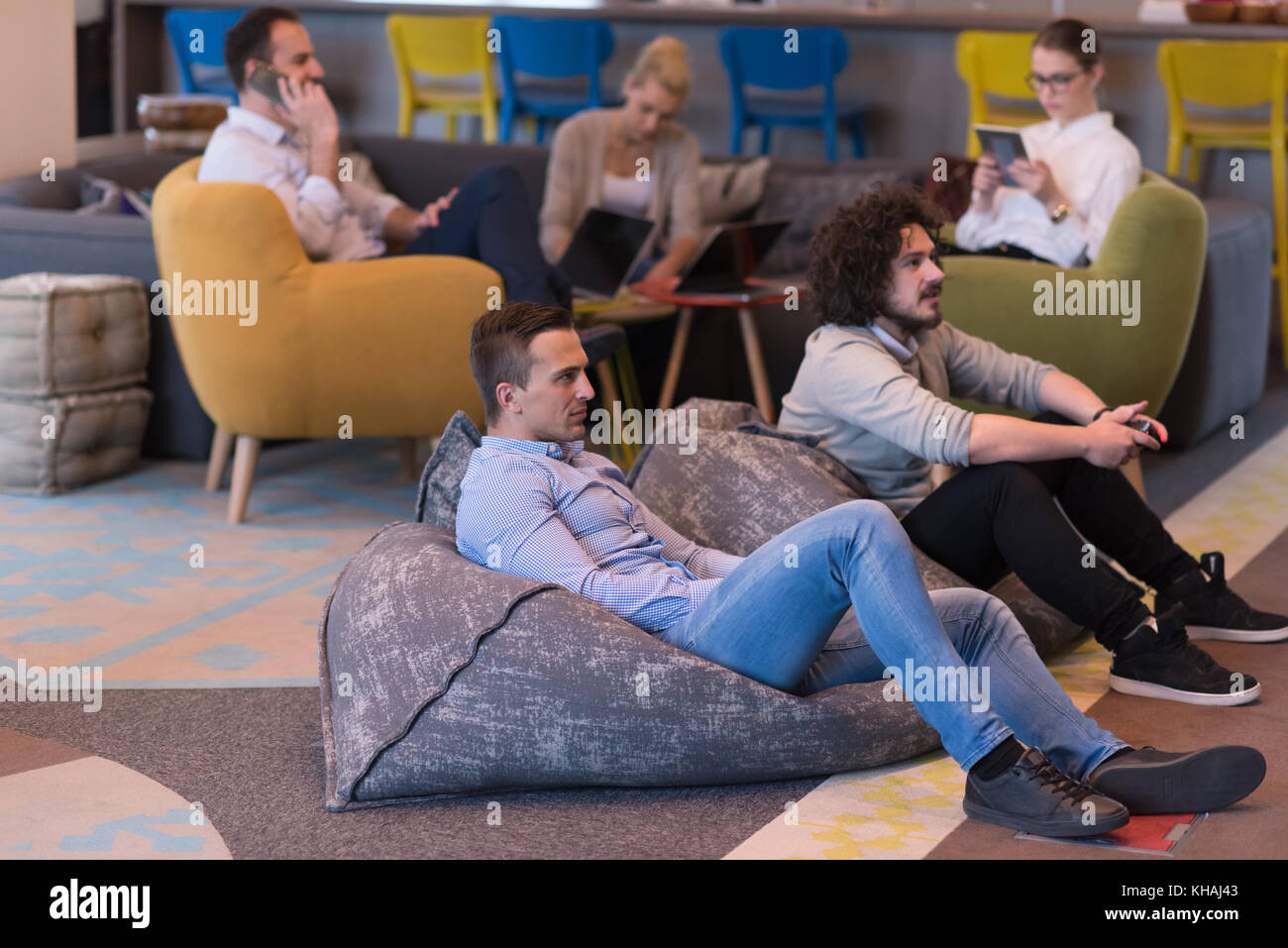 Work hard play hard. Workers Playing computer games in creative startup ...