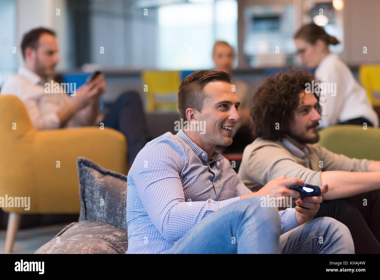 Work hard play hard. Workers Playing computer games in creative startup ...