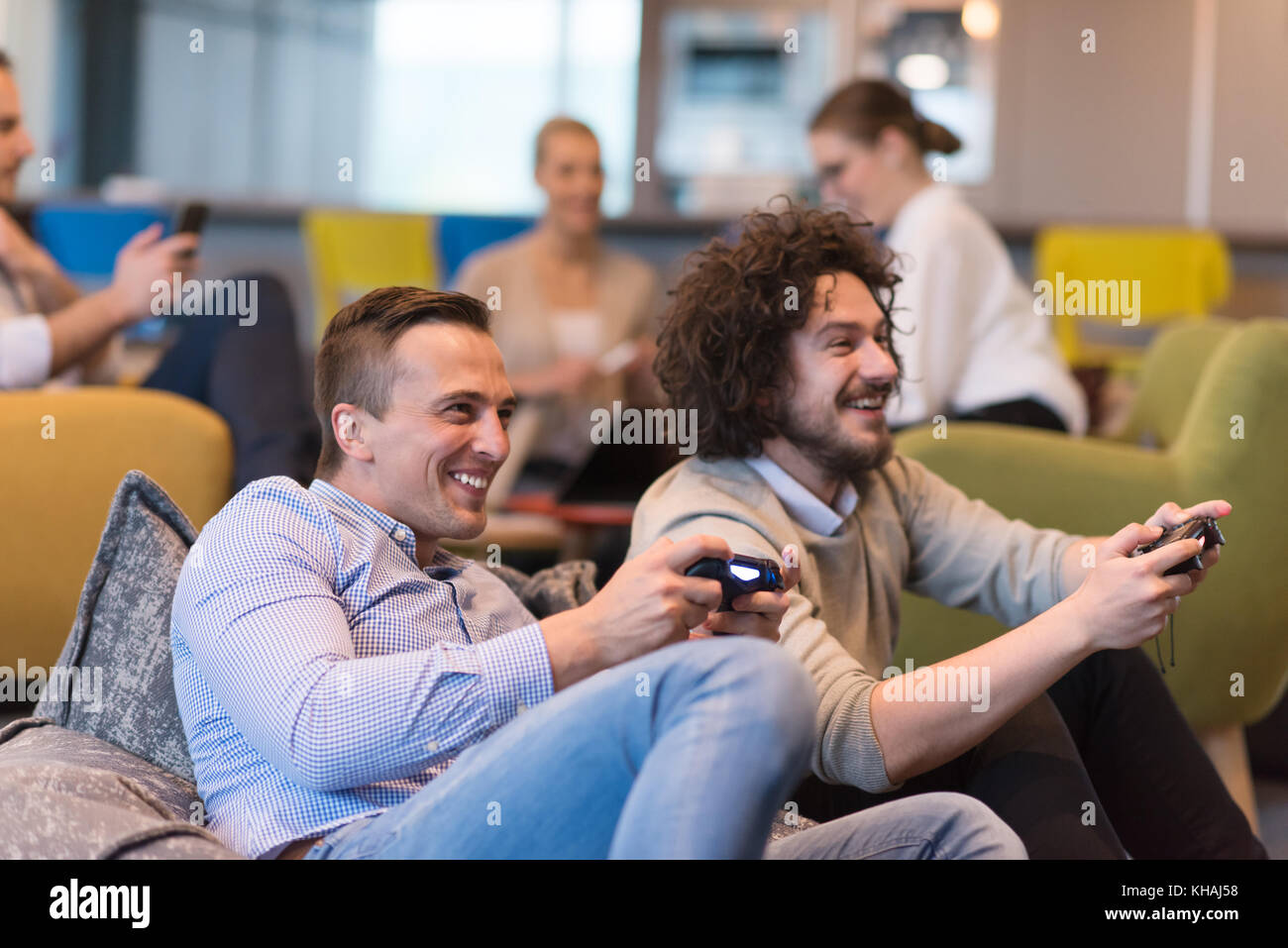 Work hard play hard. Workers Playing computer games in creative startup ...