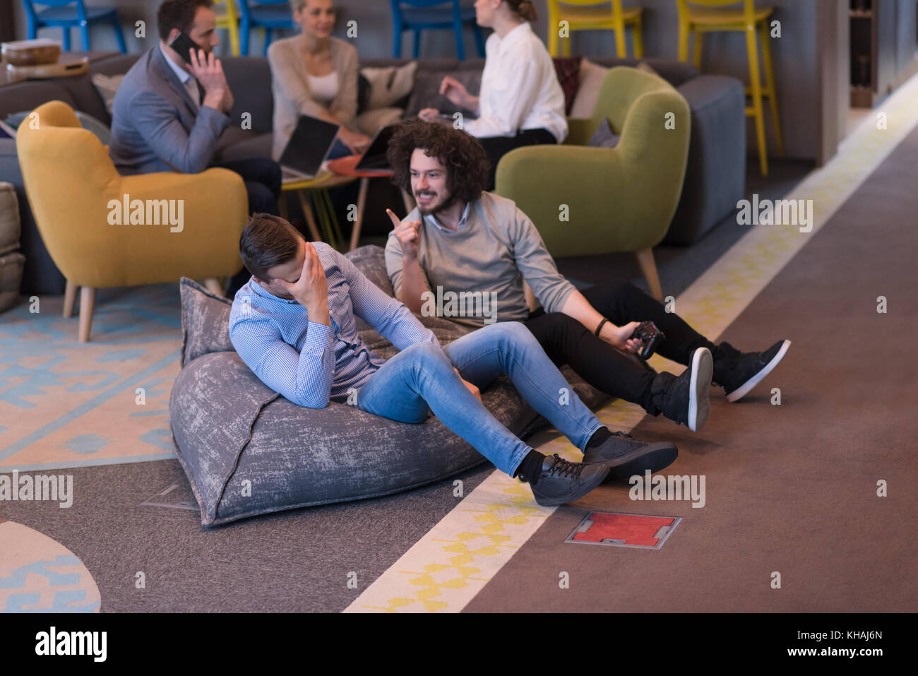 Work hard play hard. Workers Playing computer games in creative startup ...