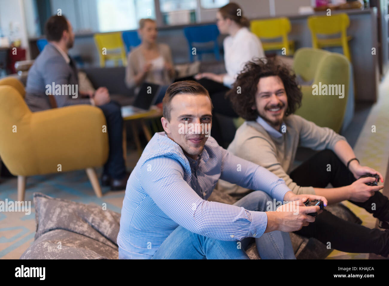 Work hard play hard. Workers Playing computer games in creative startup ...